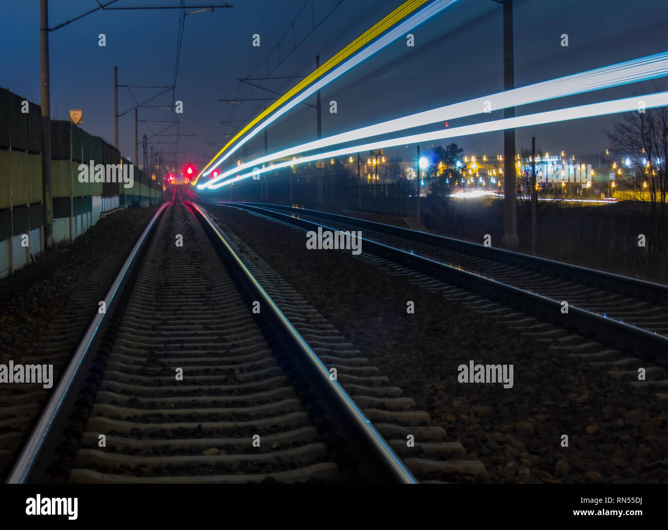 Train light trail with yellow and blue light, long exposure Stock Photo ...