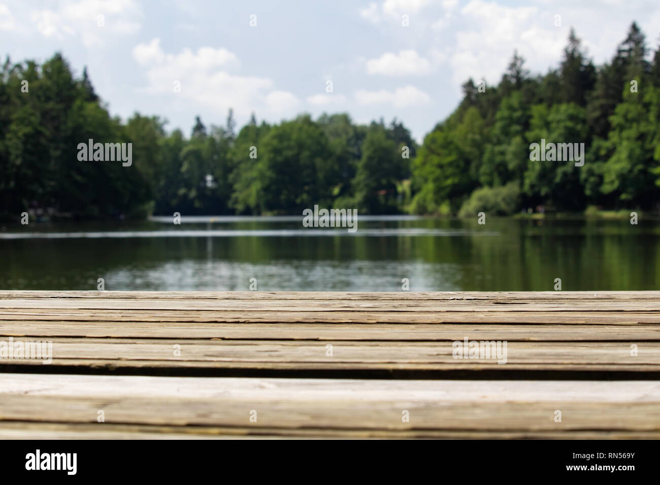 Wood jetty in pond, copy space with blured background Stock Photo - Alamy