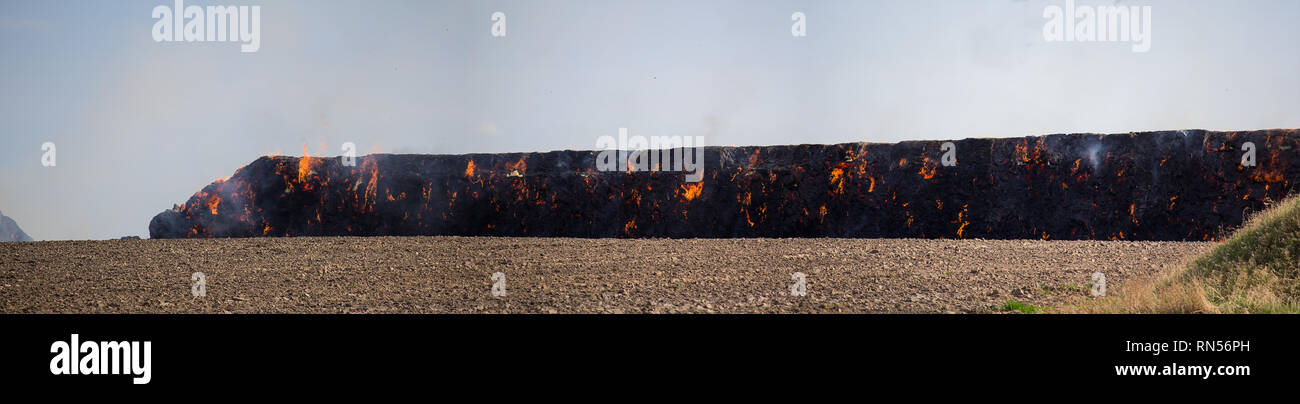 Detail of stack hay in fire on field and sky Stock Photo - Alamy