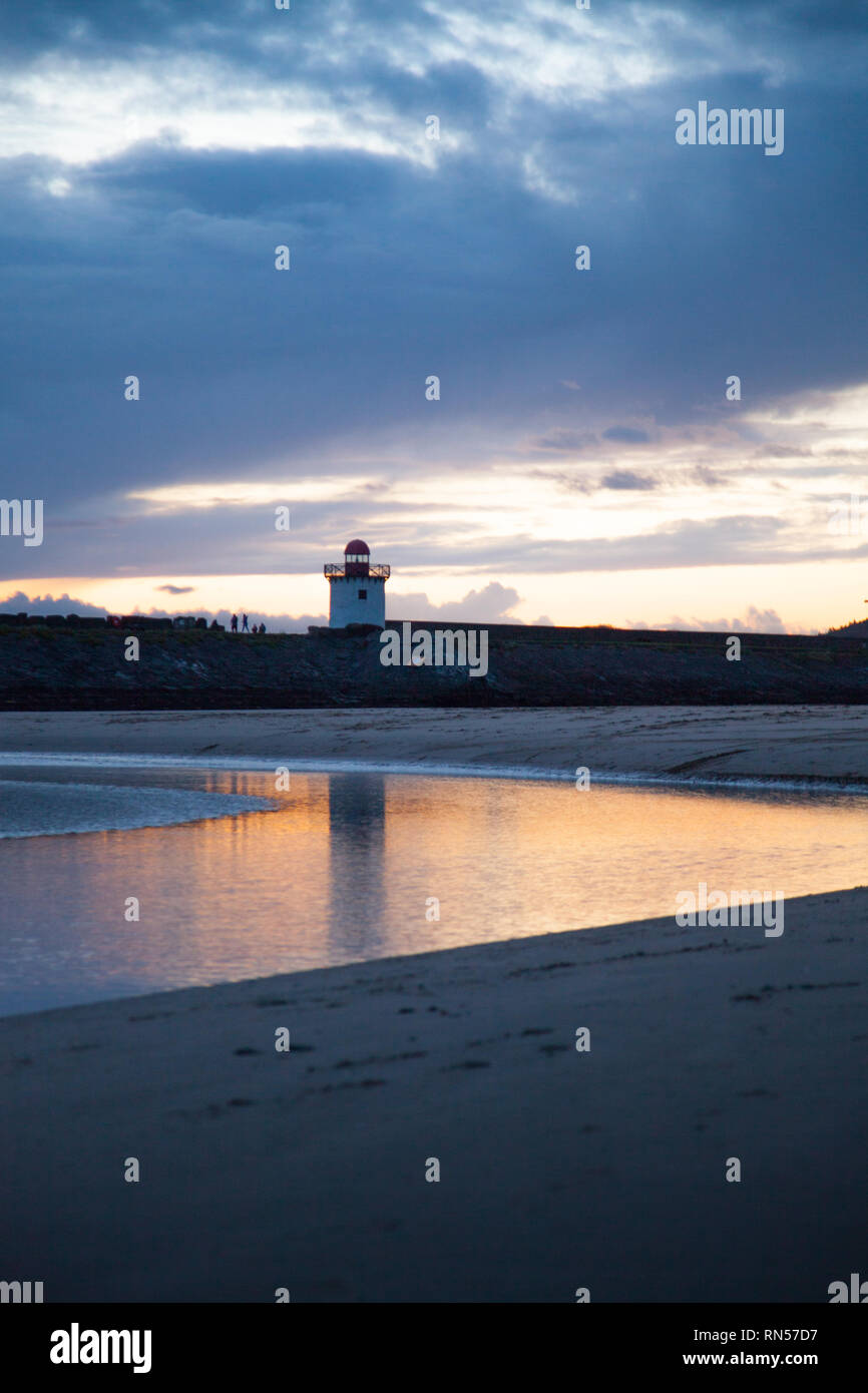 Lighthouse in Burry port in wales reflected in pool of water on beach ...