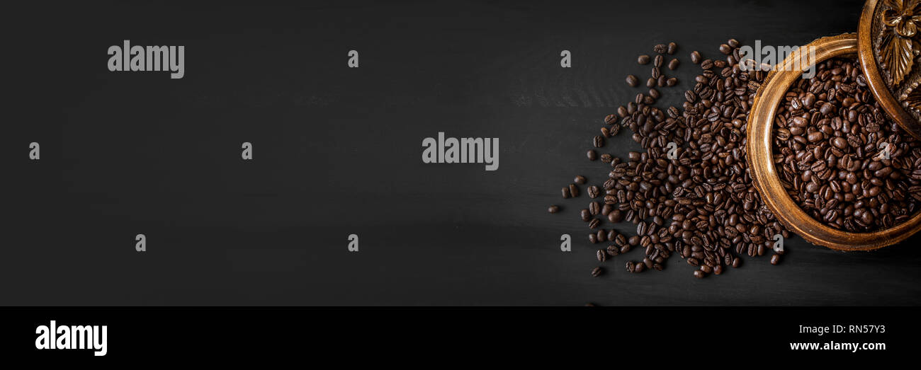 Fresh roasted arabica and robusta coffee beans. Coffee in a wooden bowl ...