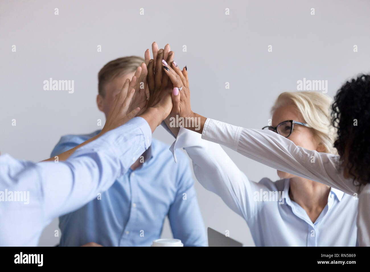 Workmates feels happy giving high five celebrating great work results ...