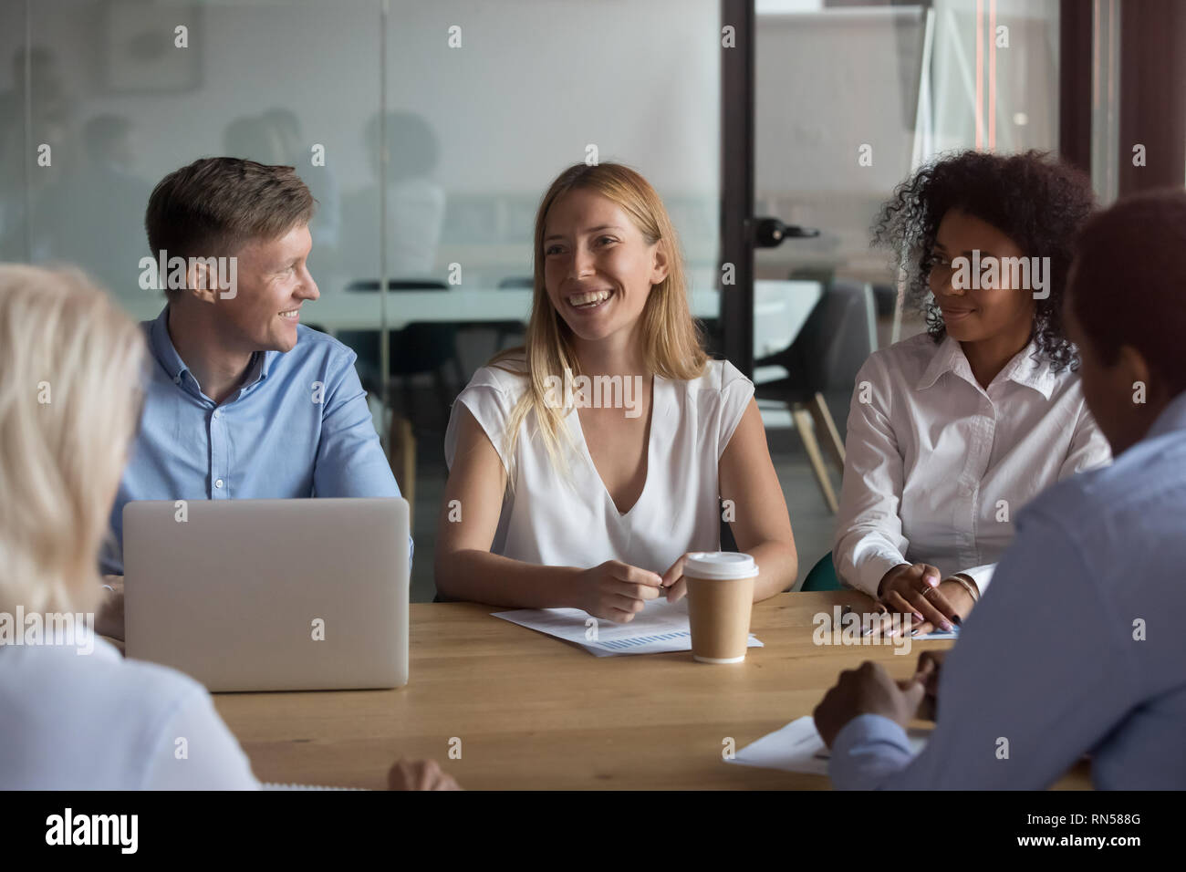 Different business people sitting together in boardroom desk and ...