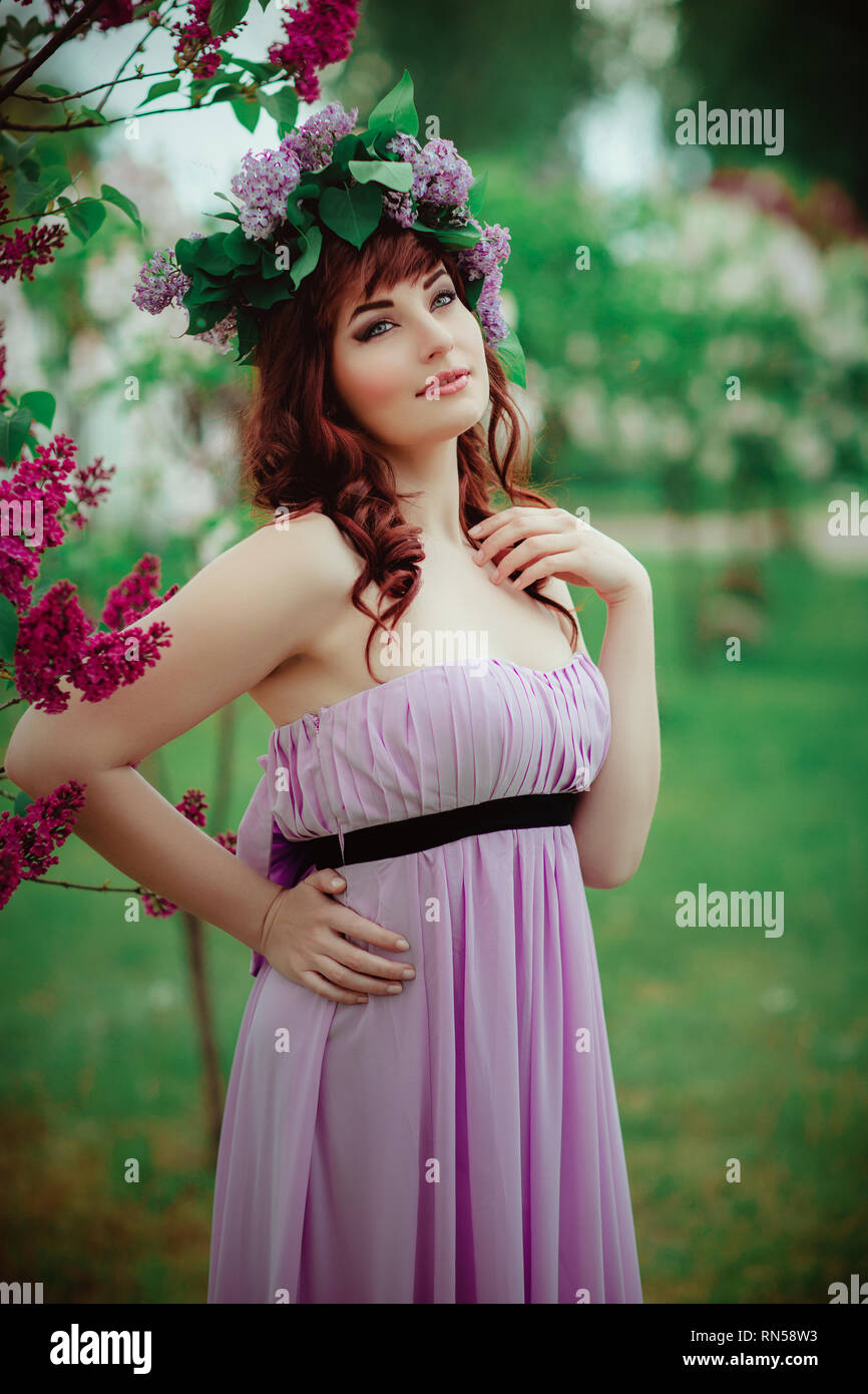 beautiful girl in purple dress with lilac flowers Stock Photo - Alamy