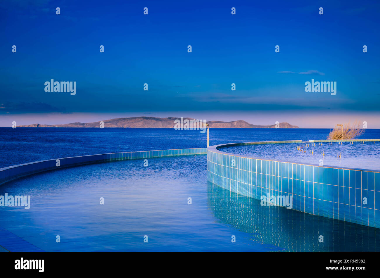 Shades of blue, where pool's artificial blue meets the deep blue of the ...