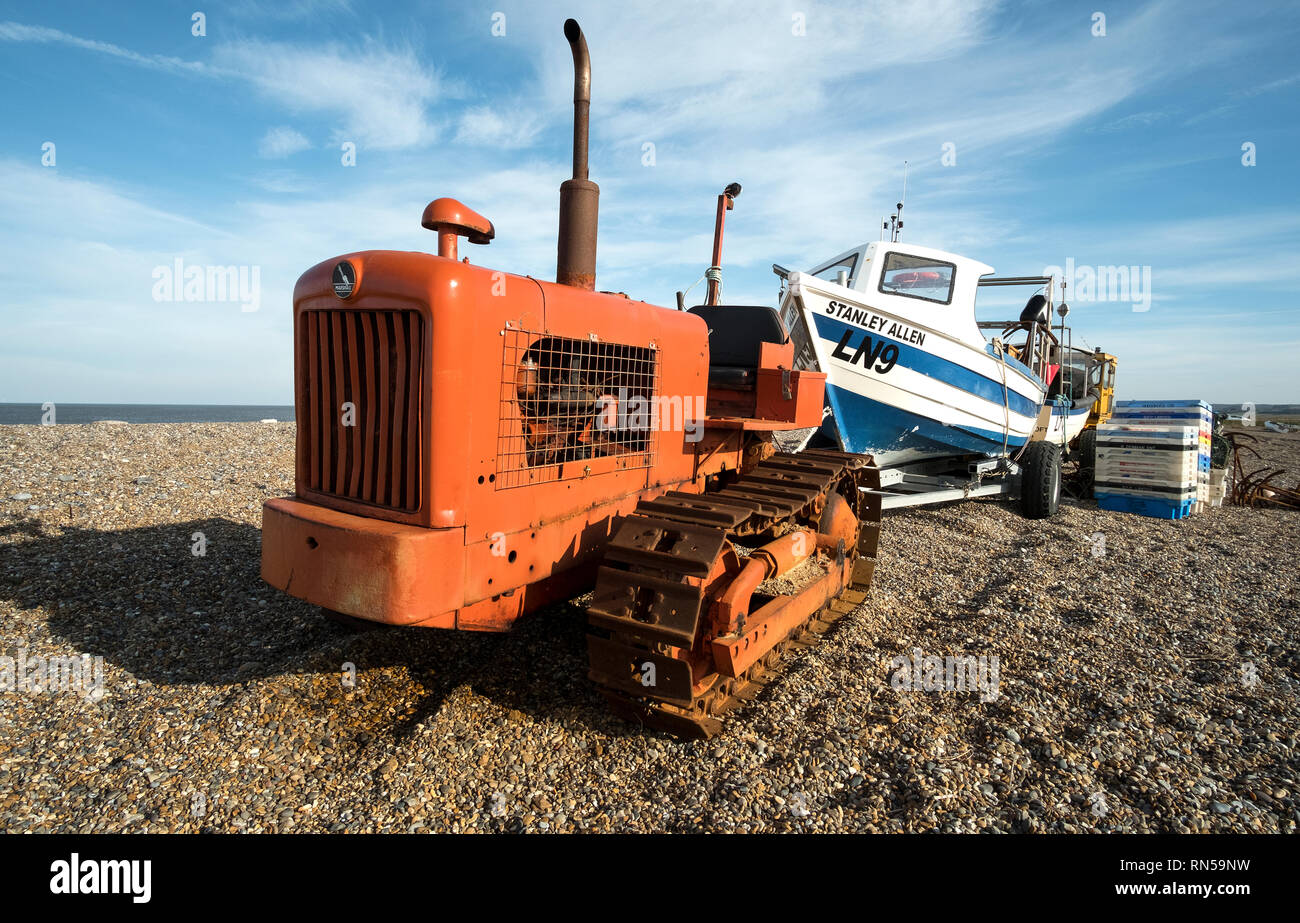 Tracked bulldozer towing a boat on a pebble beach Stock Photo - Alamy