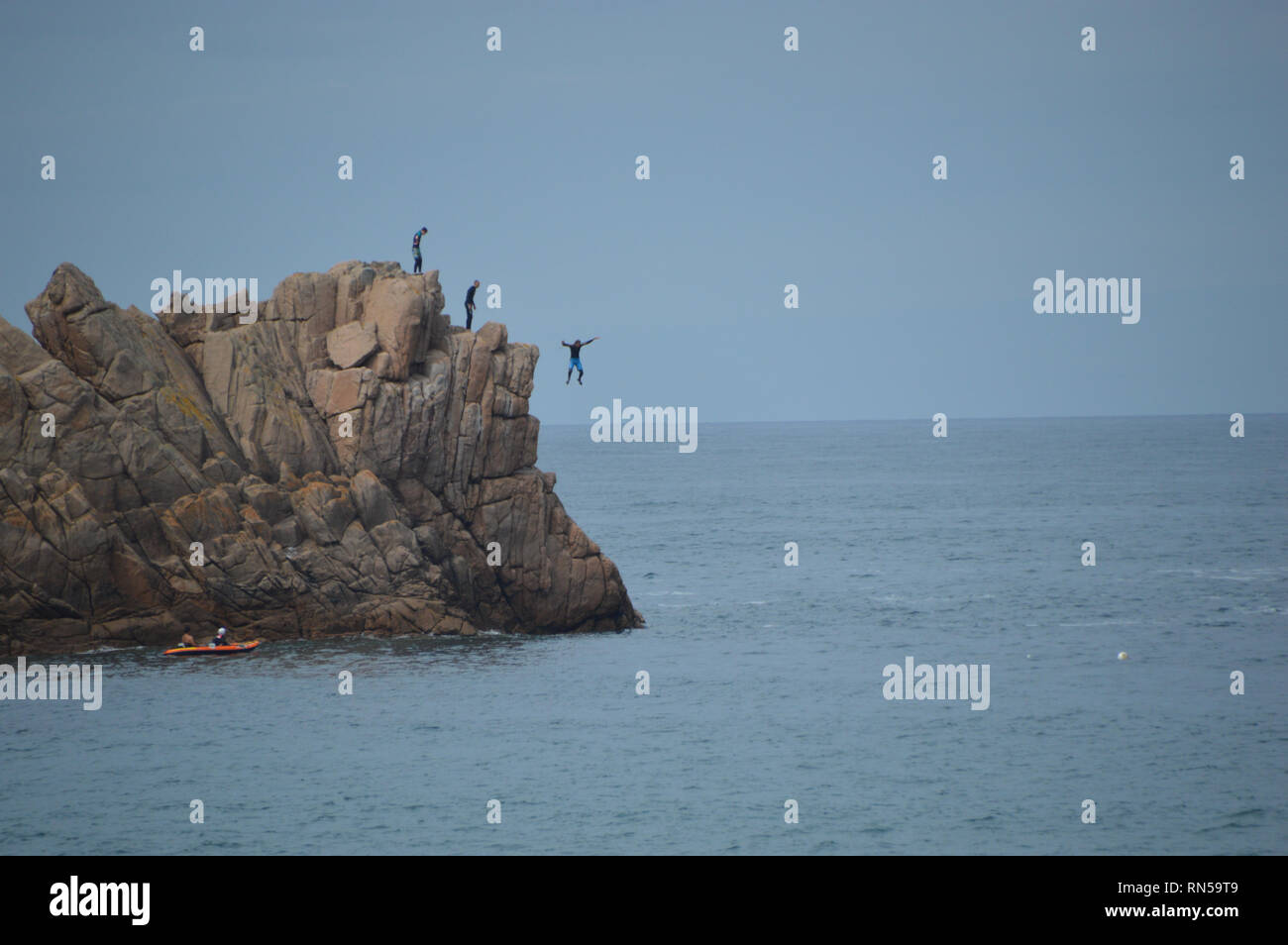 Young Men Jumping off Cliffs into the Sea 'Coasteering' seen from the ...