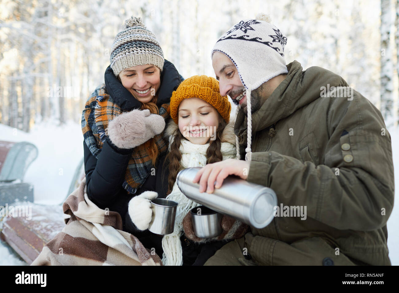 Family Drinking Cocoa in Park Stock Photo - Alamy