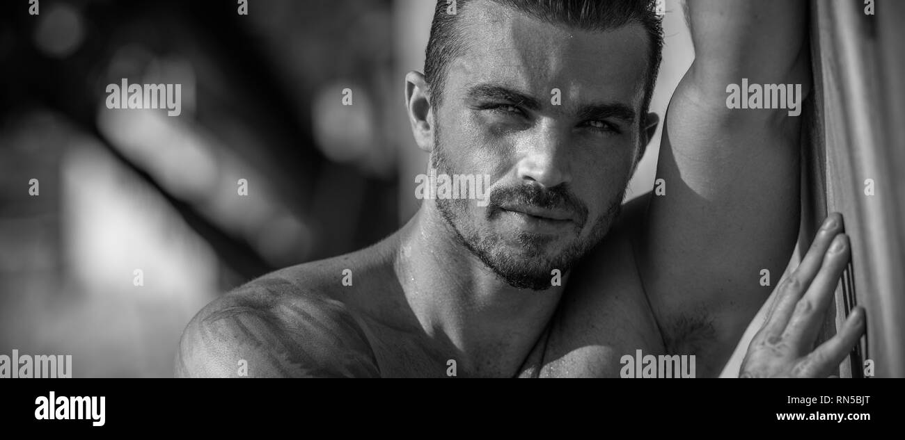 Handsome Caucasian Male Model Posing On The Beach wall Stock Photo - Alamy