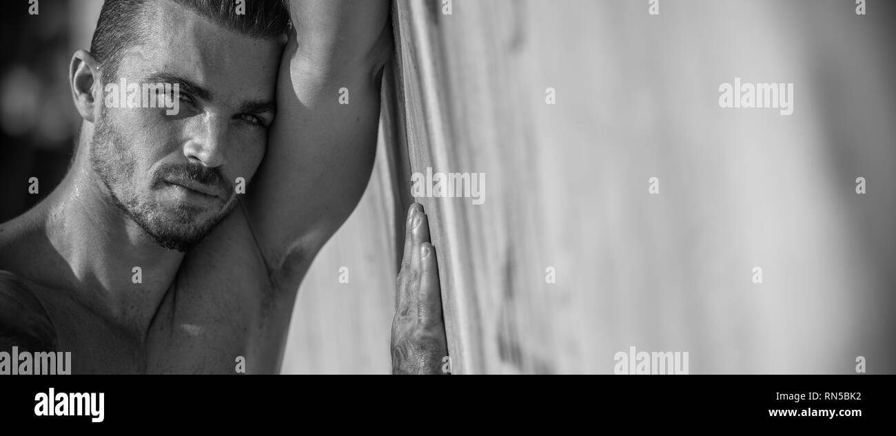 Handsome Caucasian Male Model Posing On The Beach wall Stock Photo - Alamy