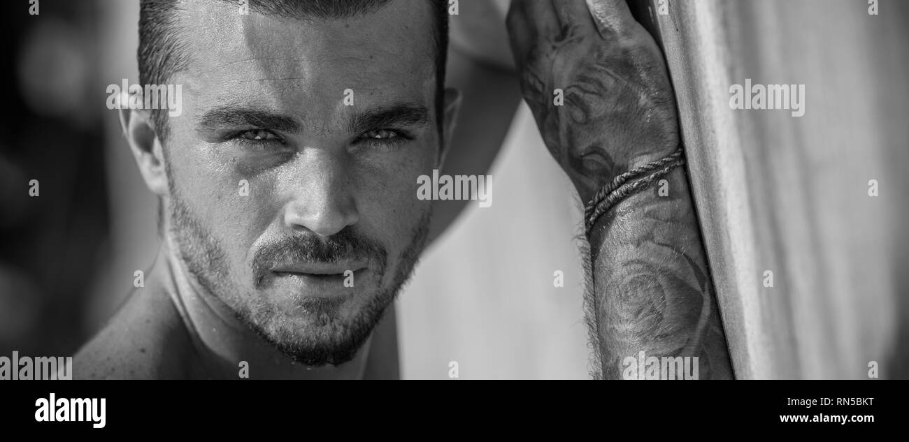 Handsome Caucasian Male Model Posing On The Beach wall Stock Photo - Alamy
