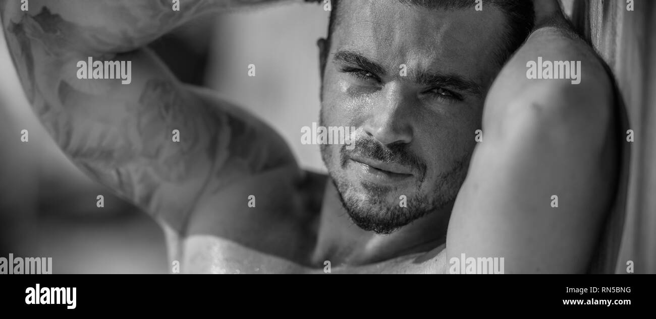 Handsome Caucasian Male Model Posing On The Beach wall Stock Photo - Alamy