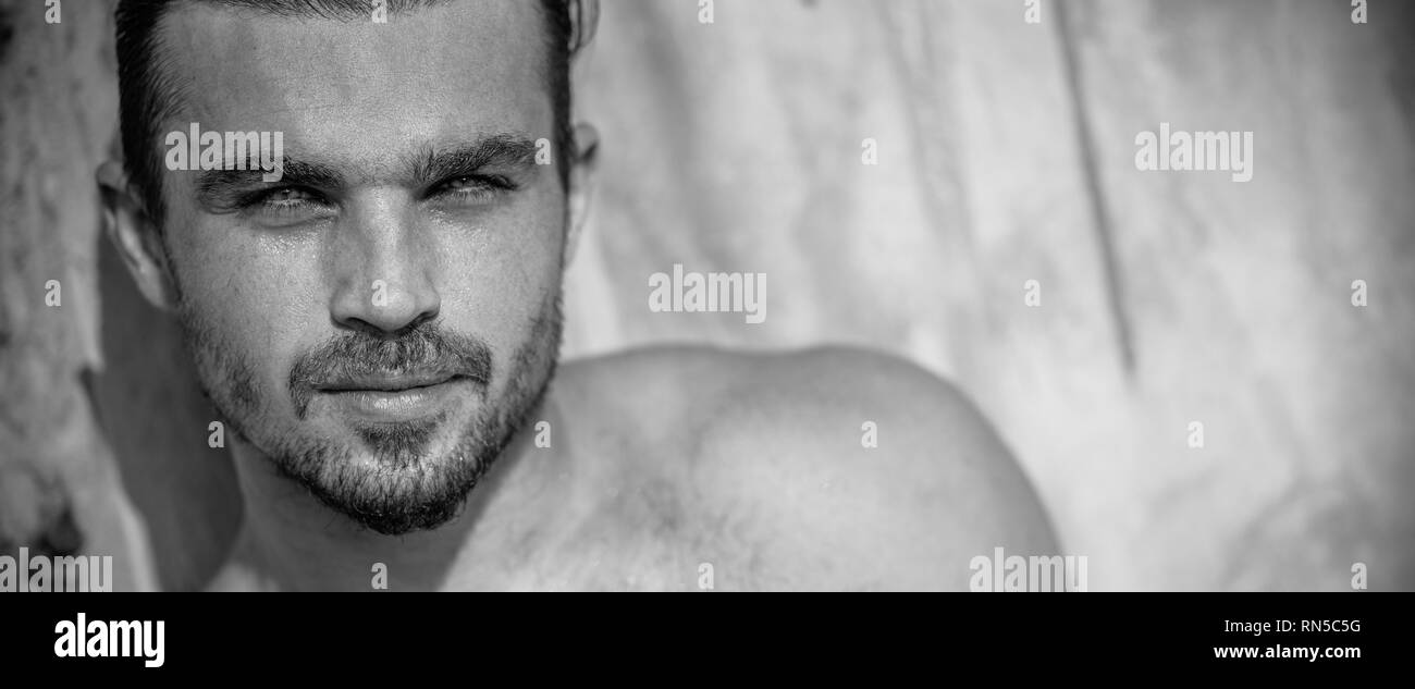 Handsome Caucasian Male Model Posing On The Beach wall Stock Photo - Alamy