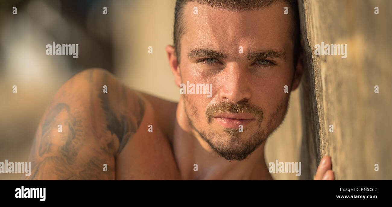 Handsome Caucasian Male Model Posing On The Beach wall Stock Photo - Alamy