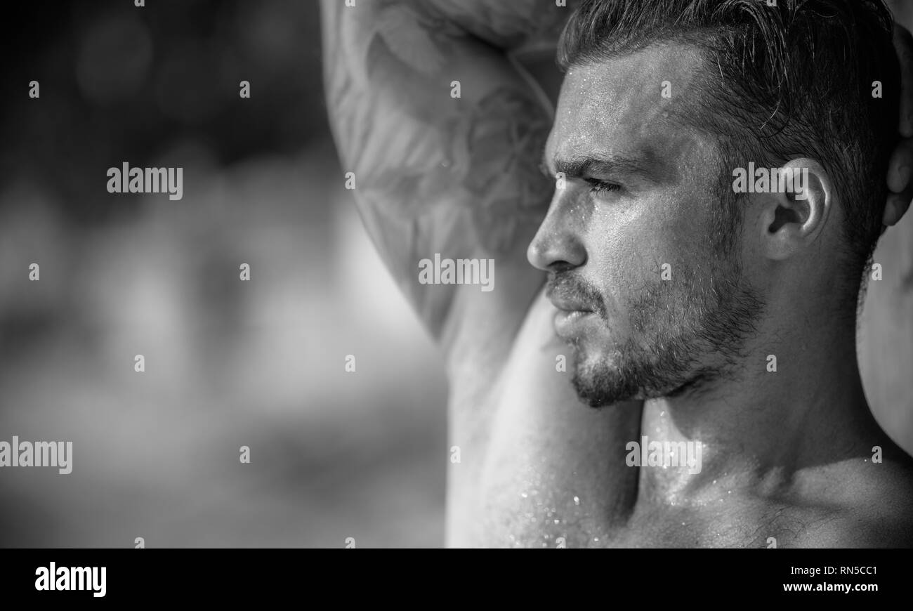 Handsome Caucasian Male Model Posing On The Beach wall Stock Photo - Alamy