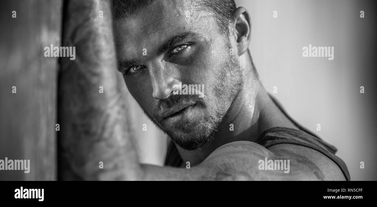 Handsome Caucasian Male Model Posing On The Beach wall Stock Photo - Alamy