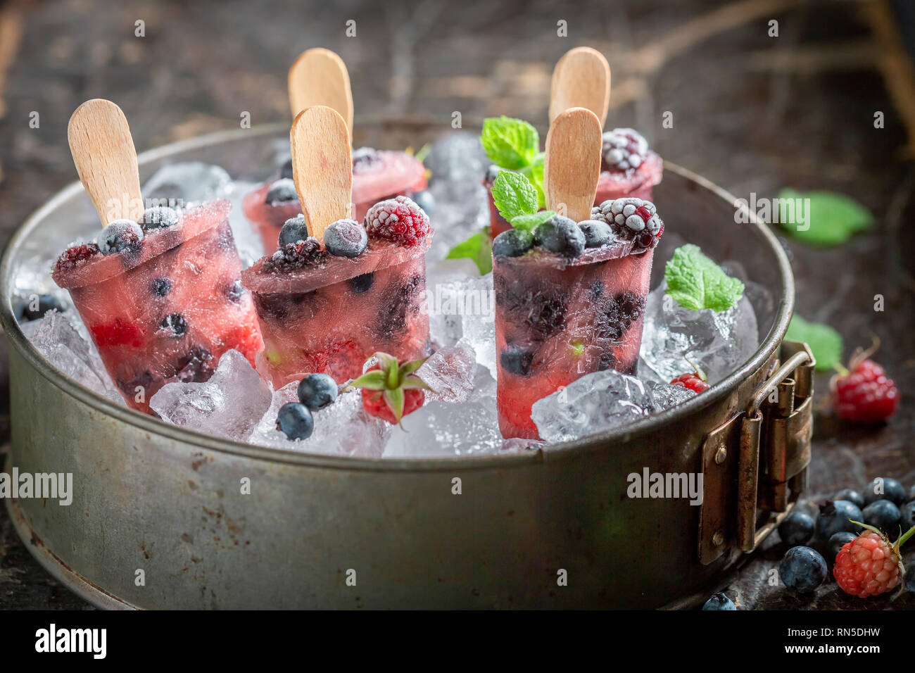Fresh berry fruits ice cream on a stick Stock Photo - Alamy