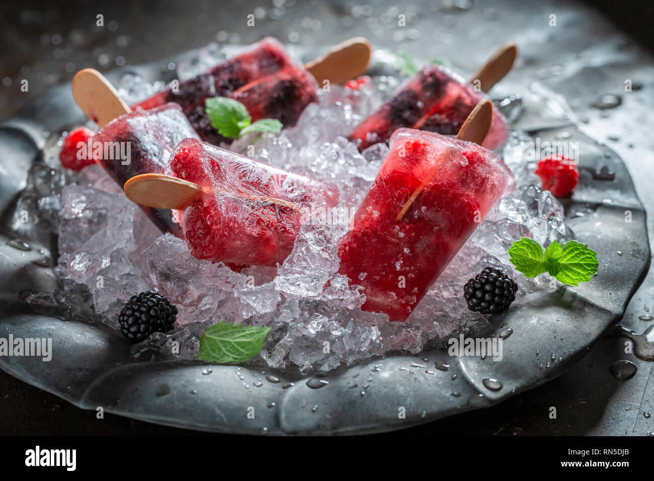Fresh berry fruits ice cream on cold ice Stock Photo - Alamy
