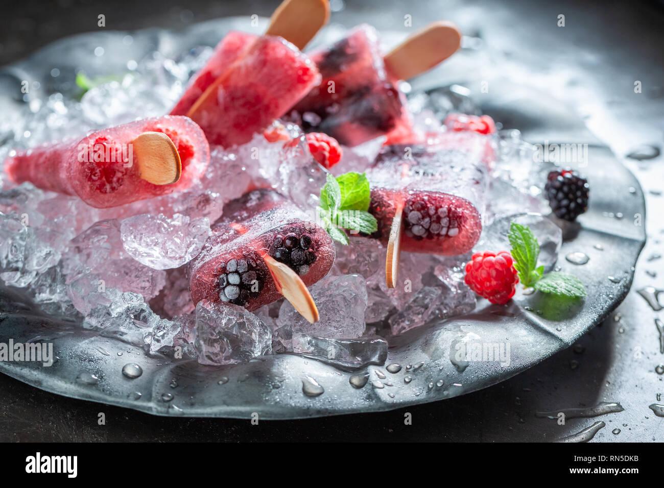 Delicious berry fruits ice cream on a stick Stock Photo - Alamy