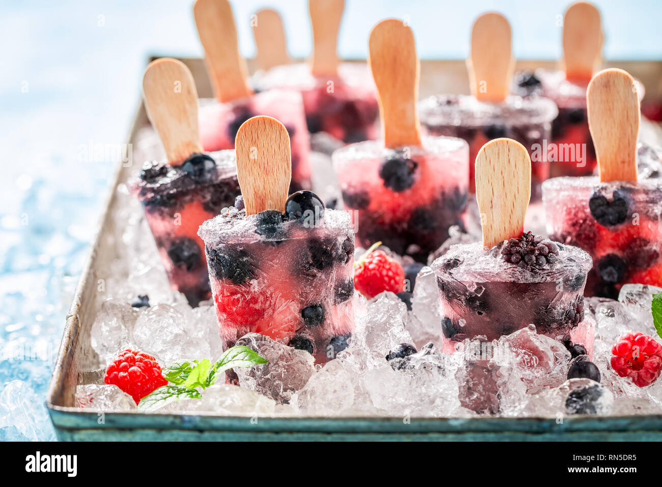 Juicy berry fruits ice cream on cold ice Stock Photo - Alamy