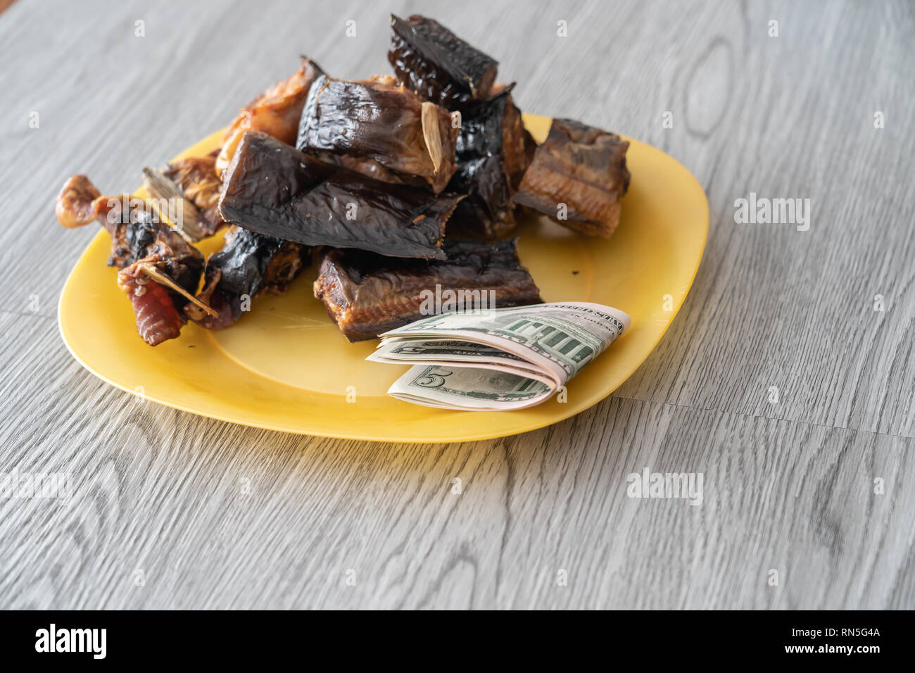 Nigerian dried roasted fish with Naira notes Stock Photo - Alamy