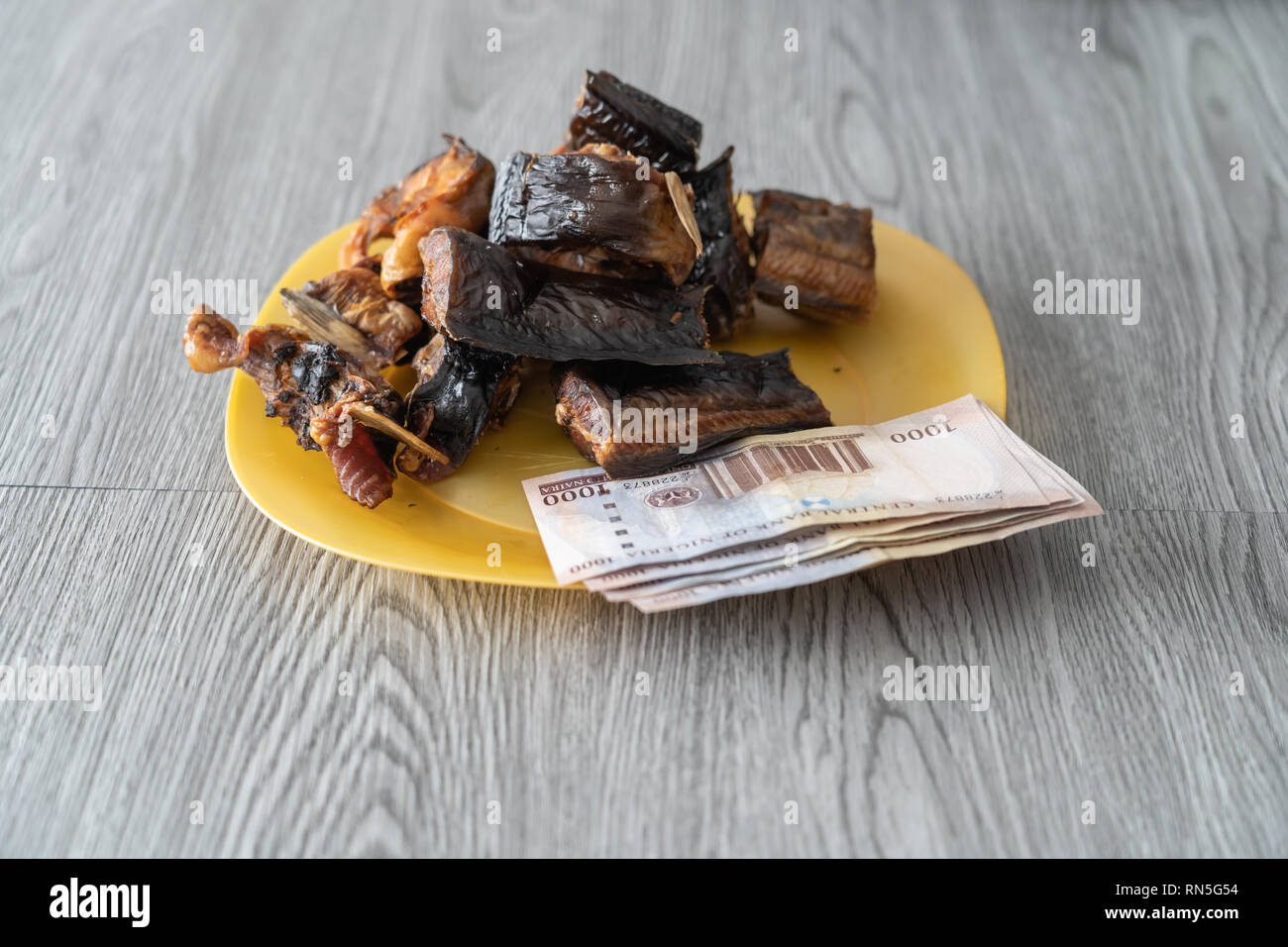 Nigerian dried roasted fish with Naira notes Stock Photo - Alamy
