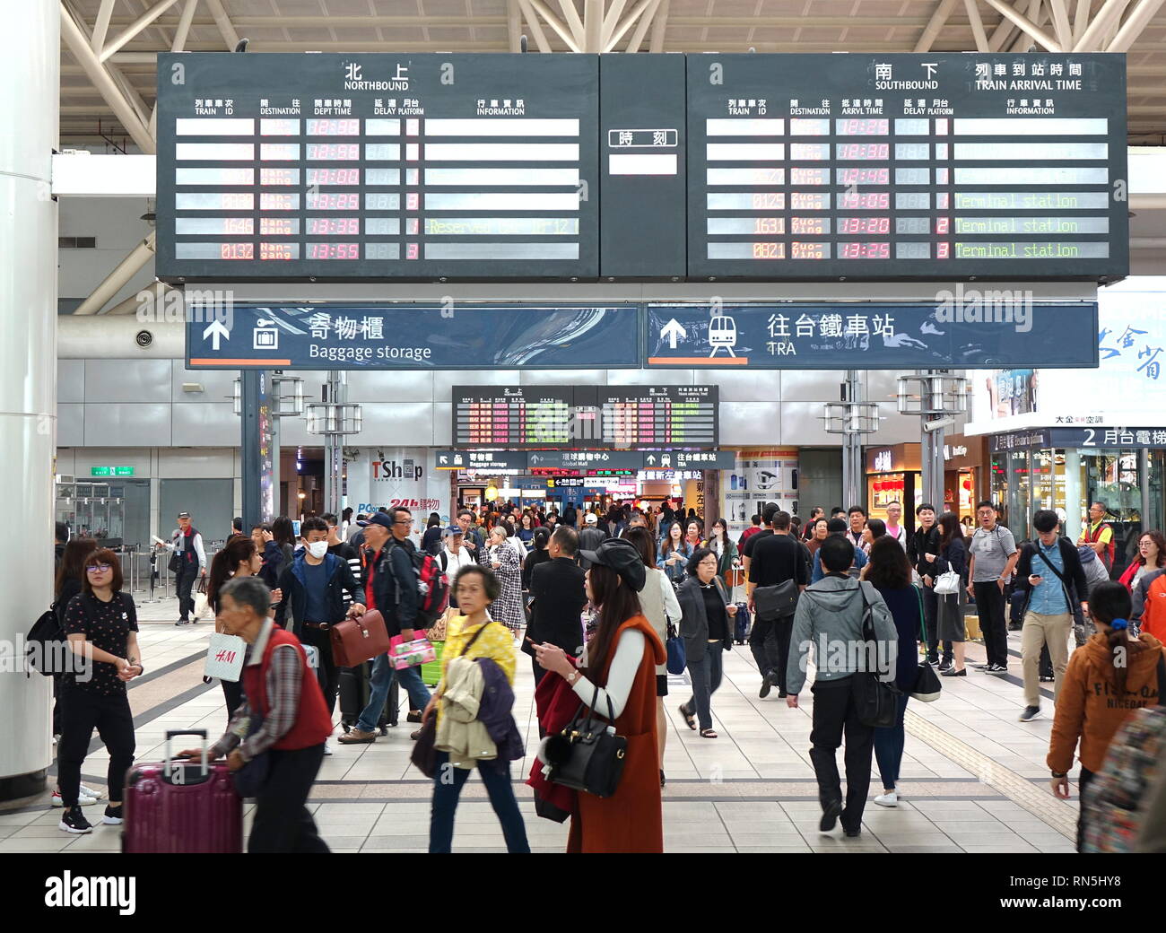 KAOHSIUNG, TAIWAN -- JANUARY 5, 2019: Commuters and travelers crowd the ...