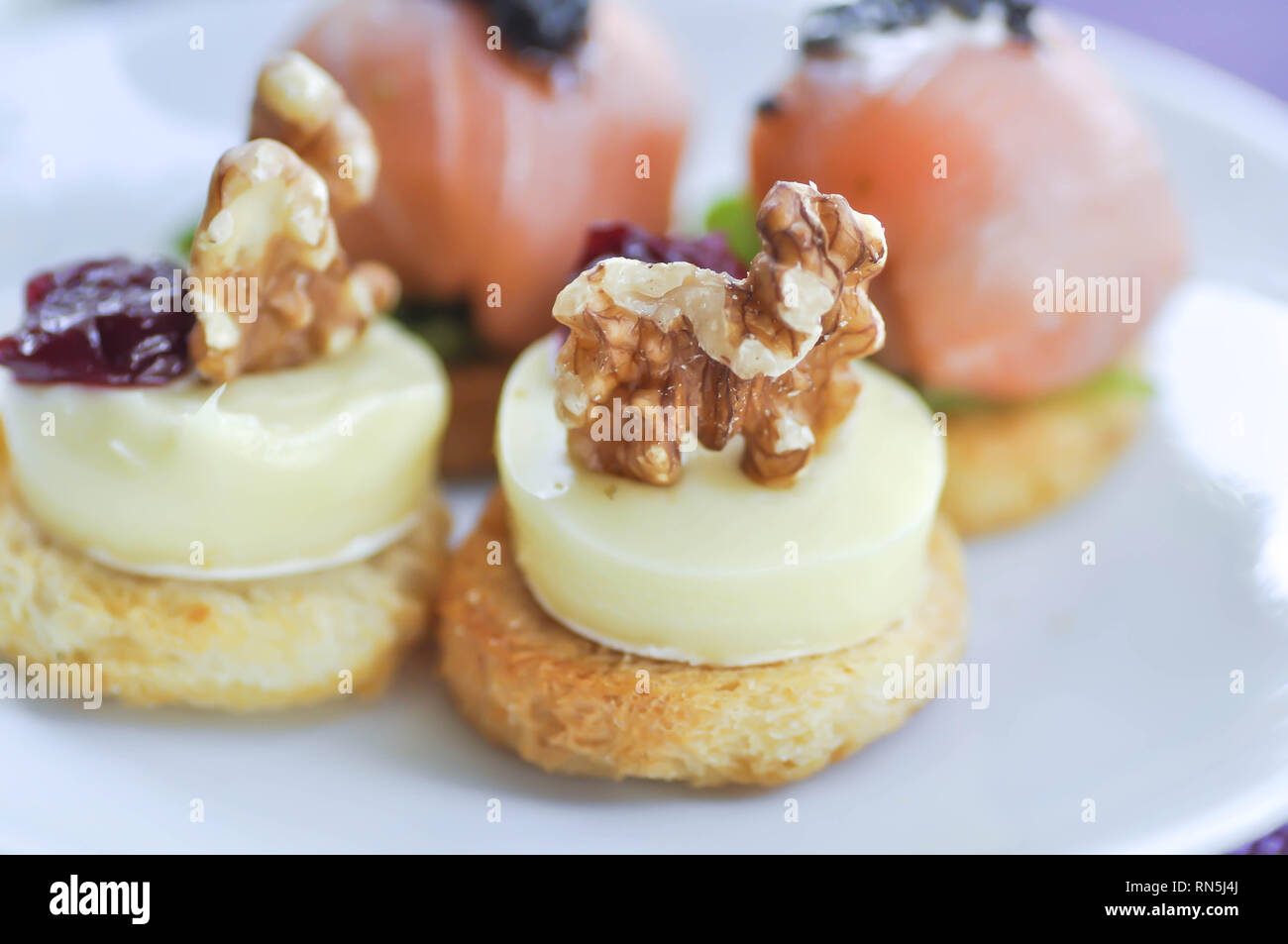 canape or chesse canape with walnut and plum topping Stock Photo - Alamy