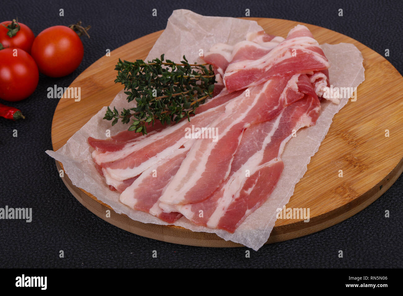 Raw bacon on the board served thyme Stock Photo - Alamy