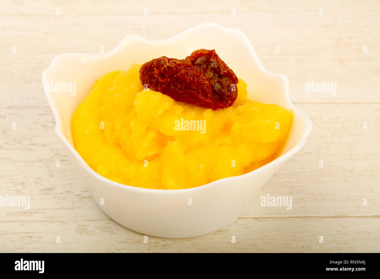 Polenta with dry tomato Stock Photo - Alamy