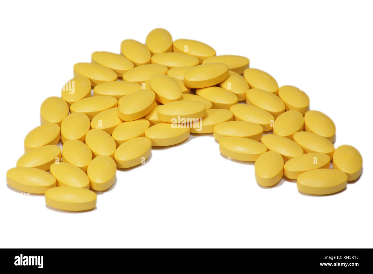 yellow vitamin on white background Stock Photo - Alamy