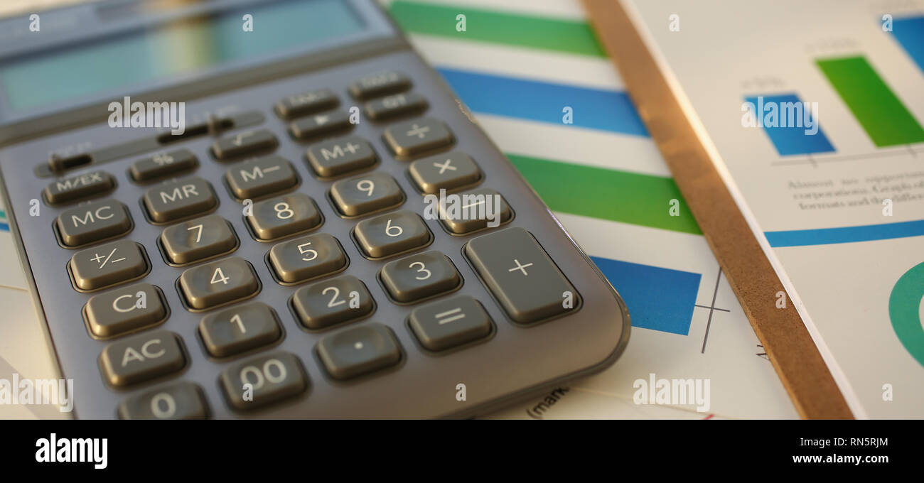 Silver calculator and financial statistics on clipboard Stock Photo - Alamy