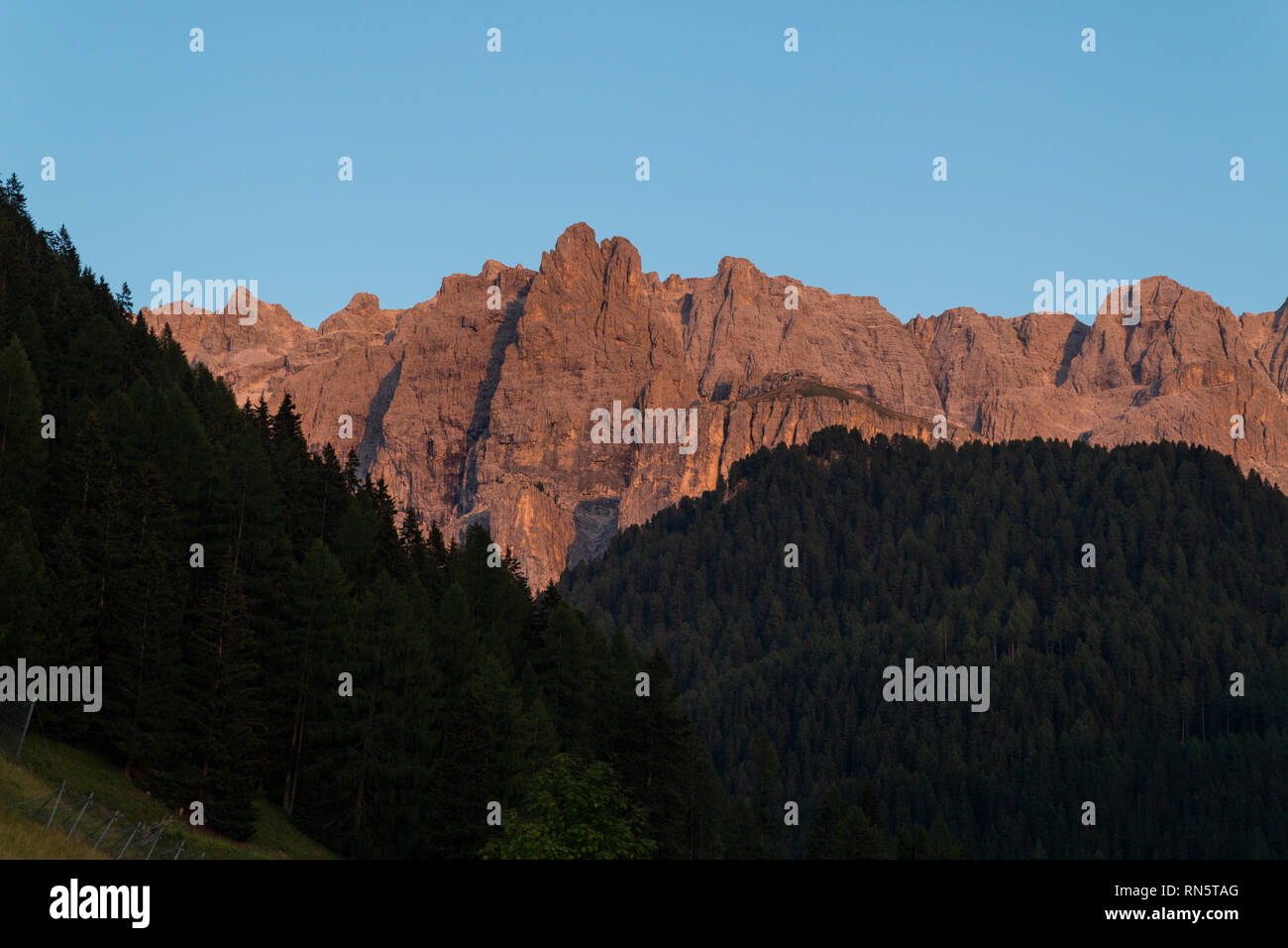 The Enrosadira phenomenon at sunset on the Dolomites of the Sella group ...
