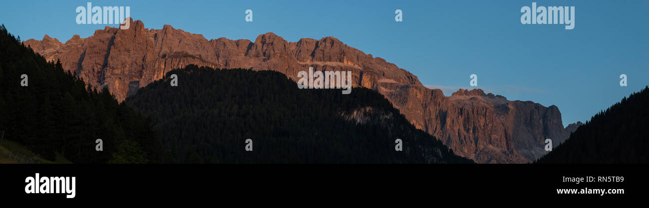The Enrosadira phenomenon at sunset on the Dolomites of the Sella group ...