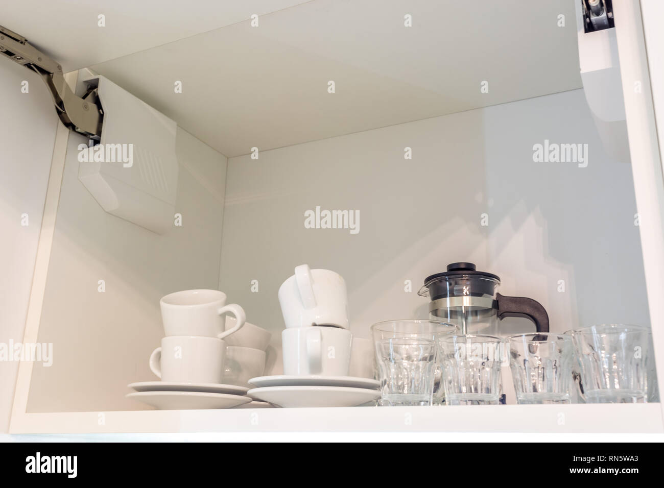 tea set and kettle on the shelf in the kitchen cupboard Stock Photo - Alamy