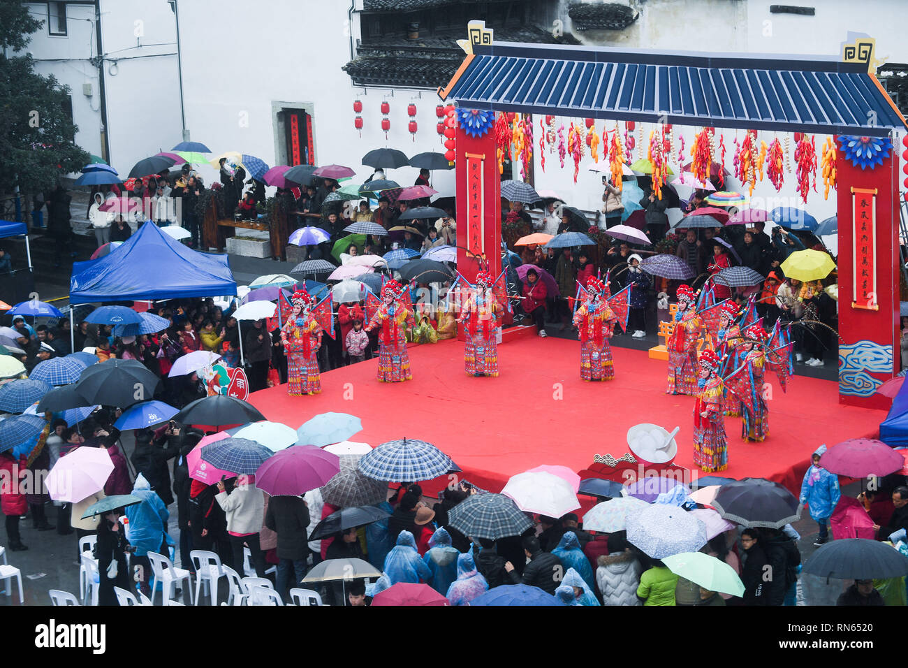 Hangzhou, China. 17th Feb, 2019. Villagers watch traditional opera ...