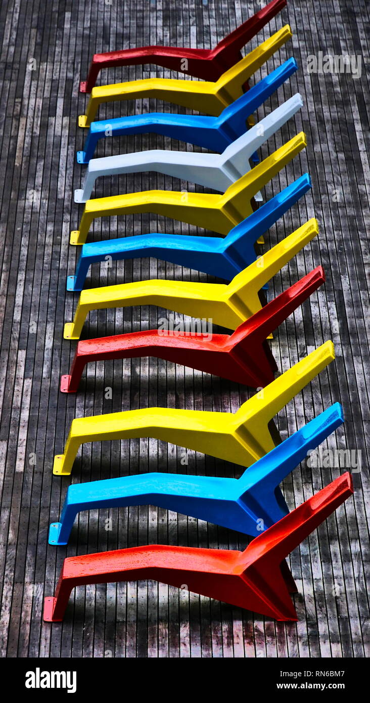 Colored pool chairs Stock Photo - Alamy