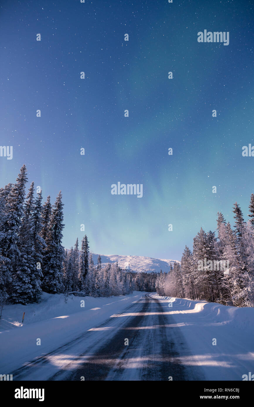 A road leading towards snow covered Pallas mountain at winter night in ...