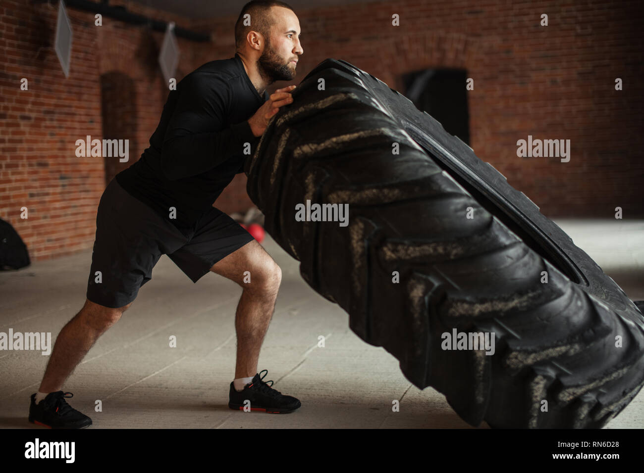 CrossFit Tire Technique. Powerful bodybuilder demonstrates rules and ...