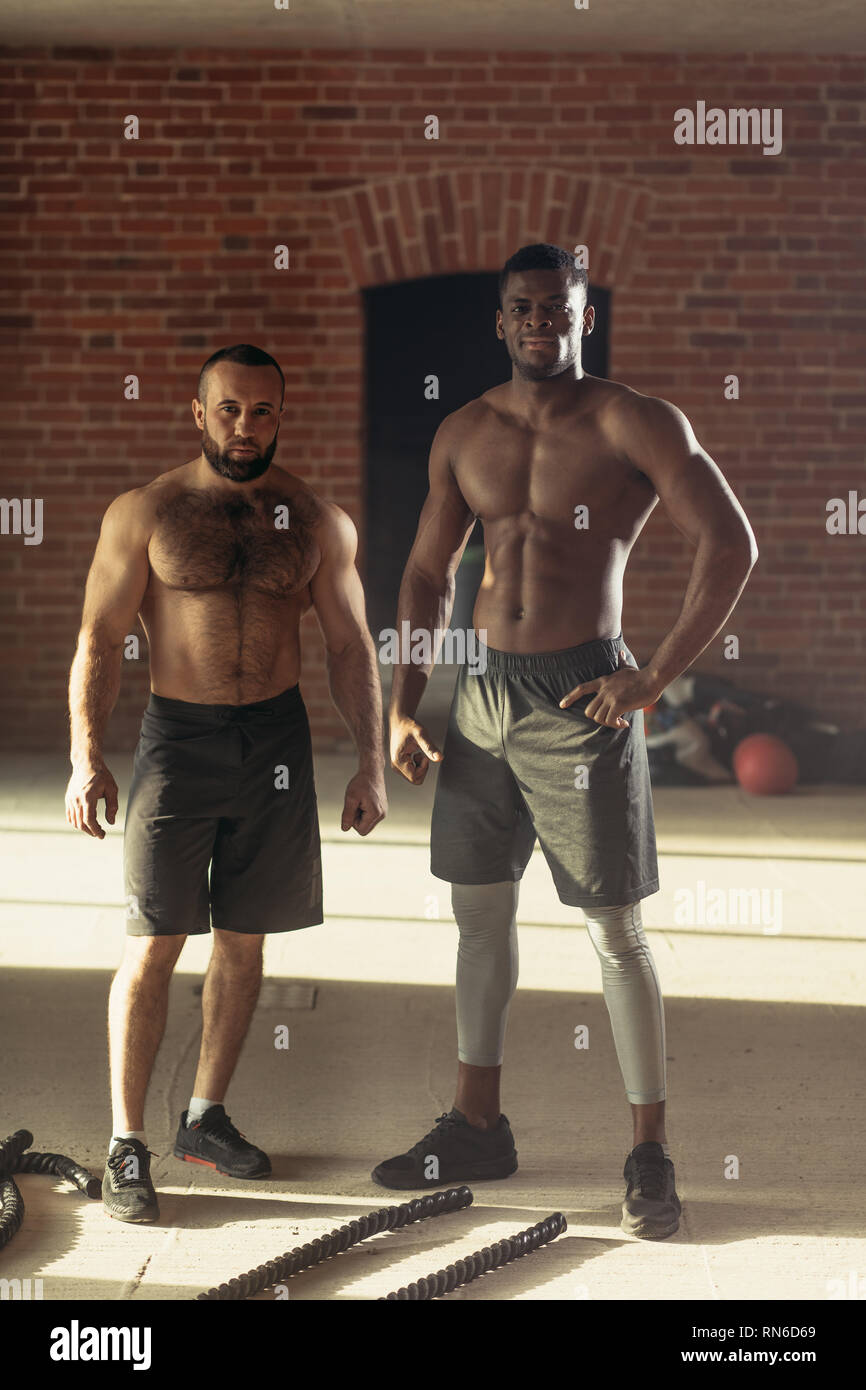 Two multiethnic shirtless male bodybuilders with perfect muscular body ...