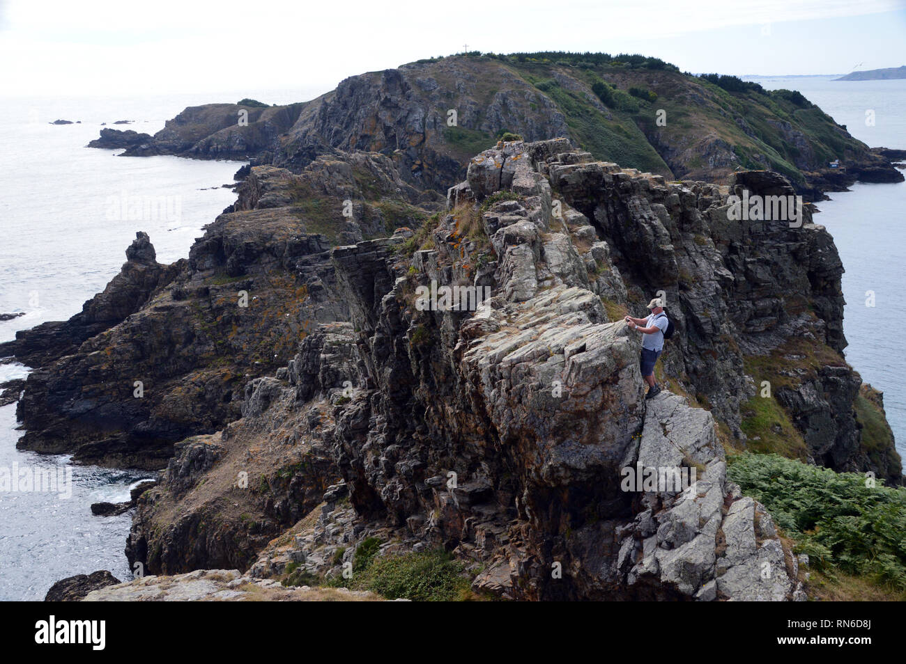 Hiker Taking a Photo of Gouliot Bay from the Headland Leading to Island ...