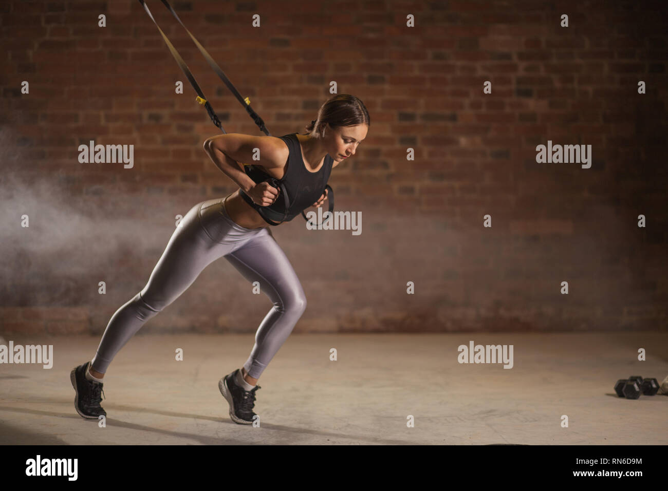 Fitness woman trainin on the TRX in the gym, doing Sprinter Start ...