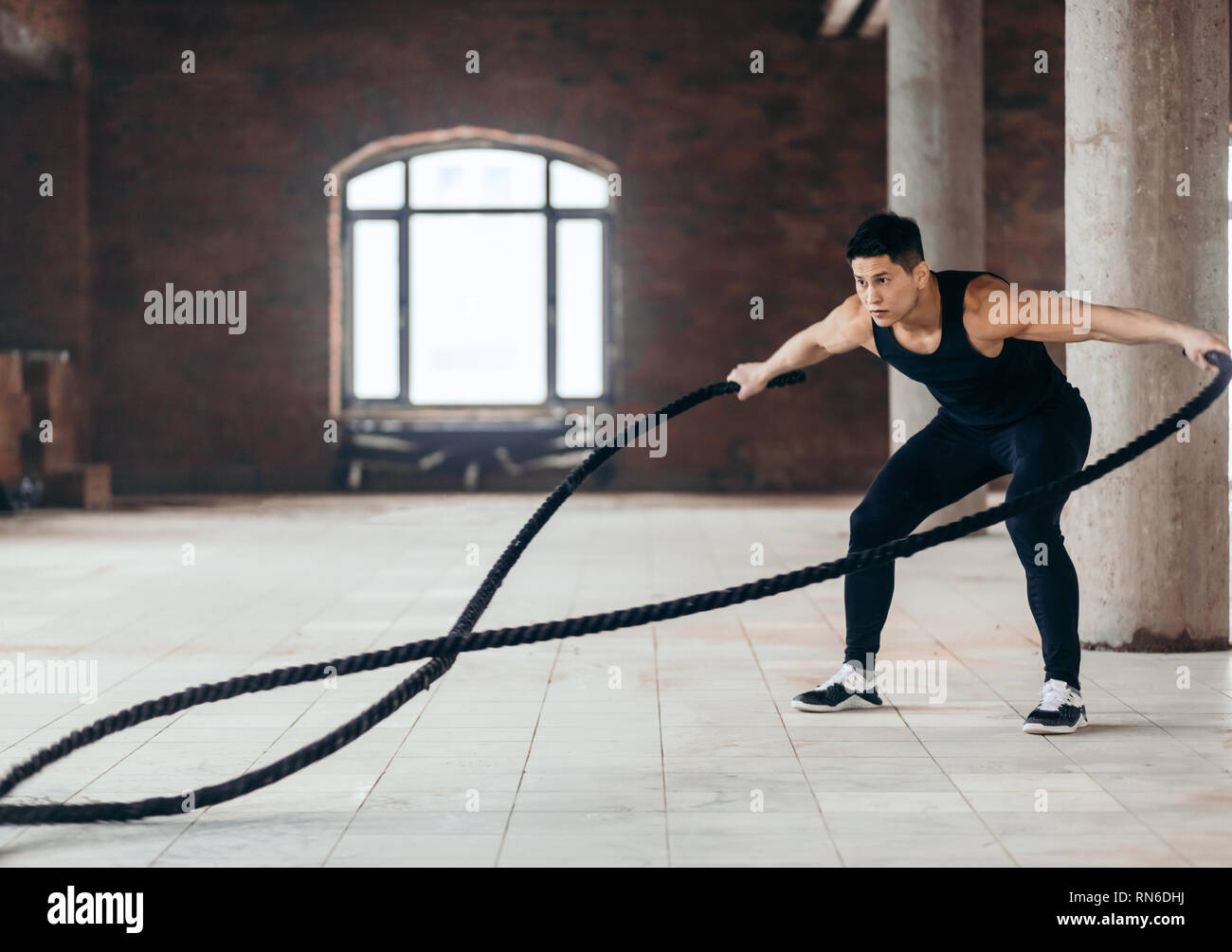 modern workout tool. awesome athlete develops muscles and cardio with ...