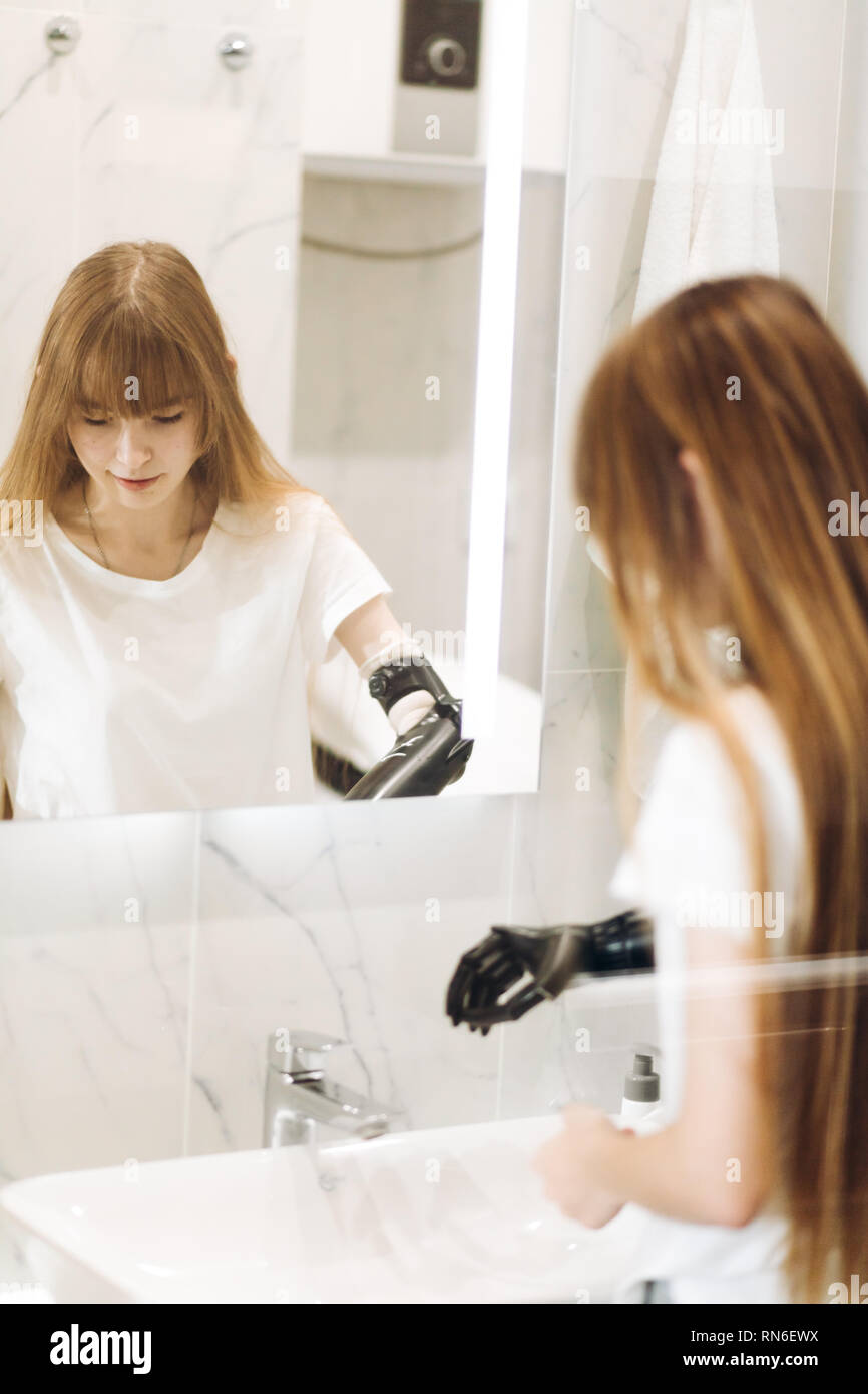 young girl with artificial arm turning on the tap in the bathroom, free ...