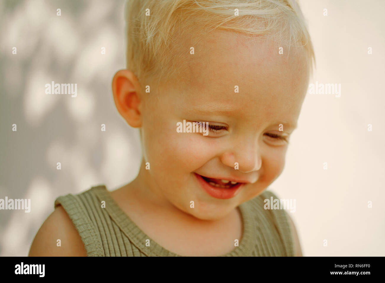 Pure as a lily. Little child with adorable smile. Happy baby. Baby boy ...