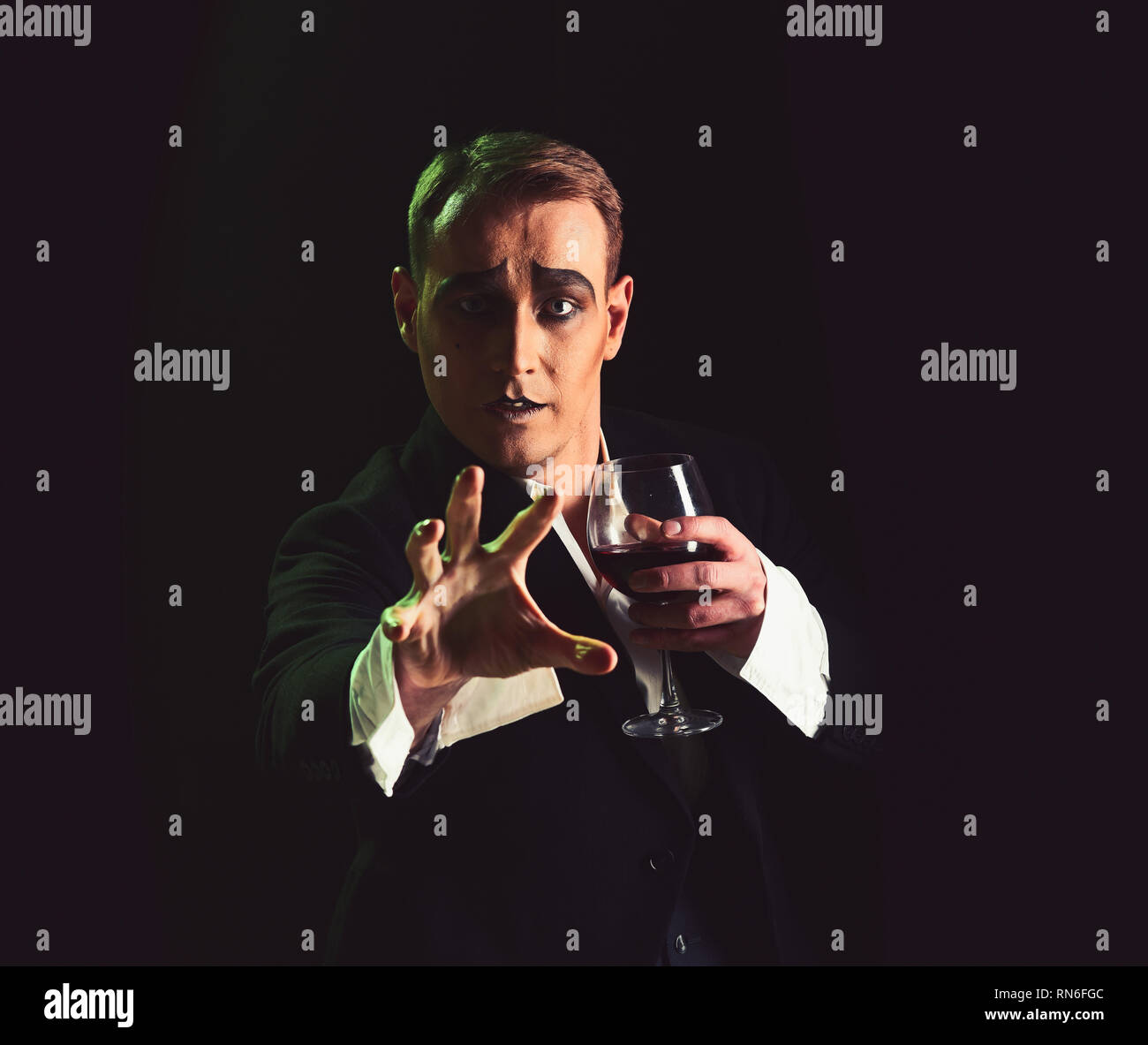 Wait. Mime artist perform on stage. Stage actor pantomime drinking wine ...