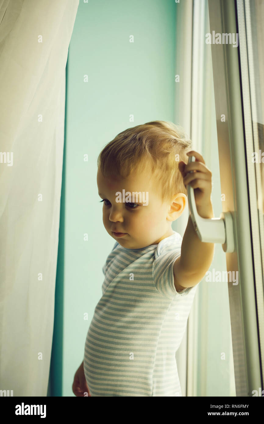 Baby boy on window sill Stock Photo - Alamy