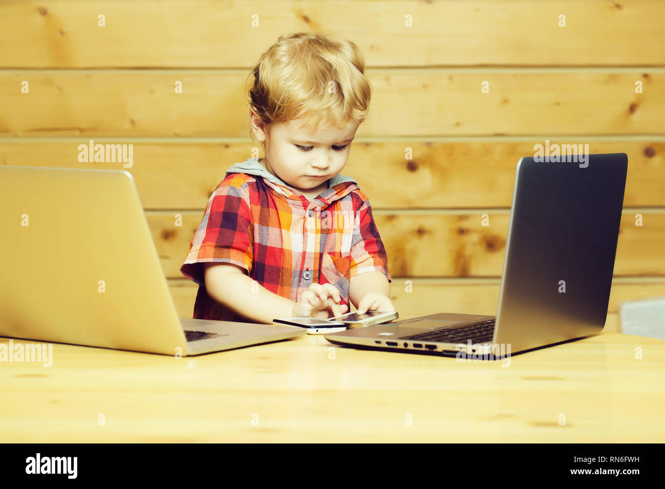 Cute boy with computers Stock Photo - Alamy