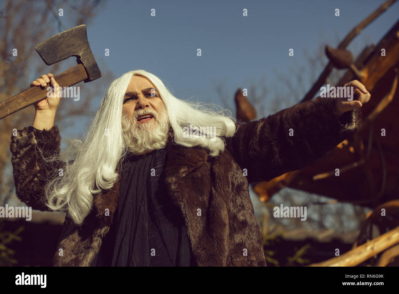 Brutal old druid with axe Stock Photo - Alamy