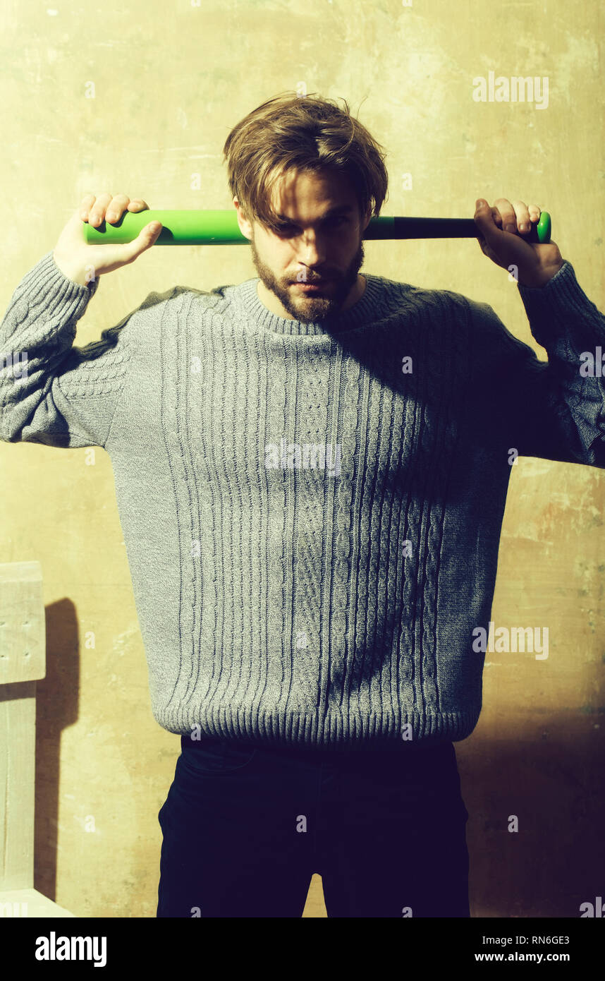 athlete holding green baseball bat behind neck Stock Photo - Alamy